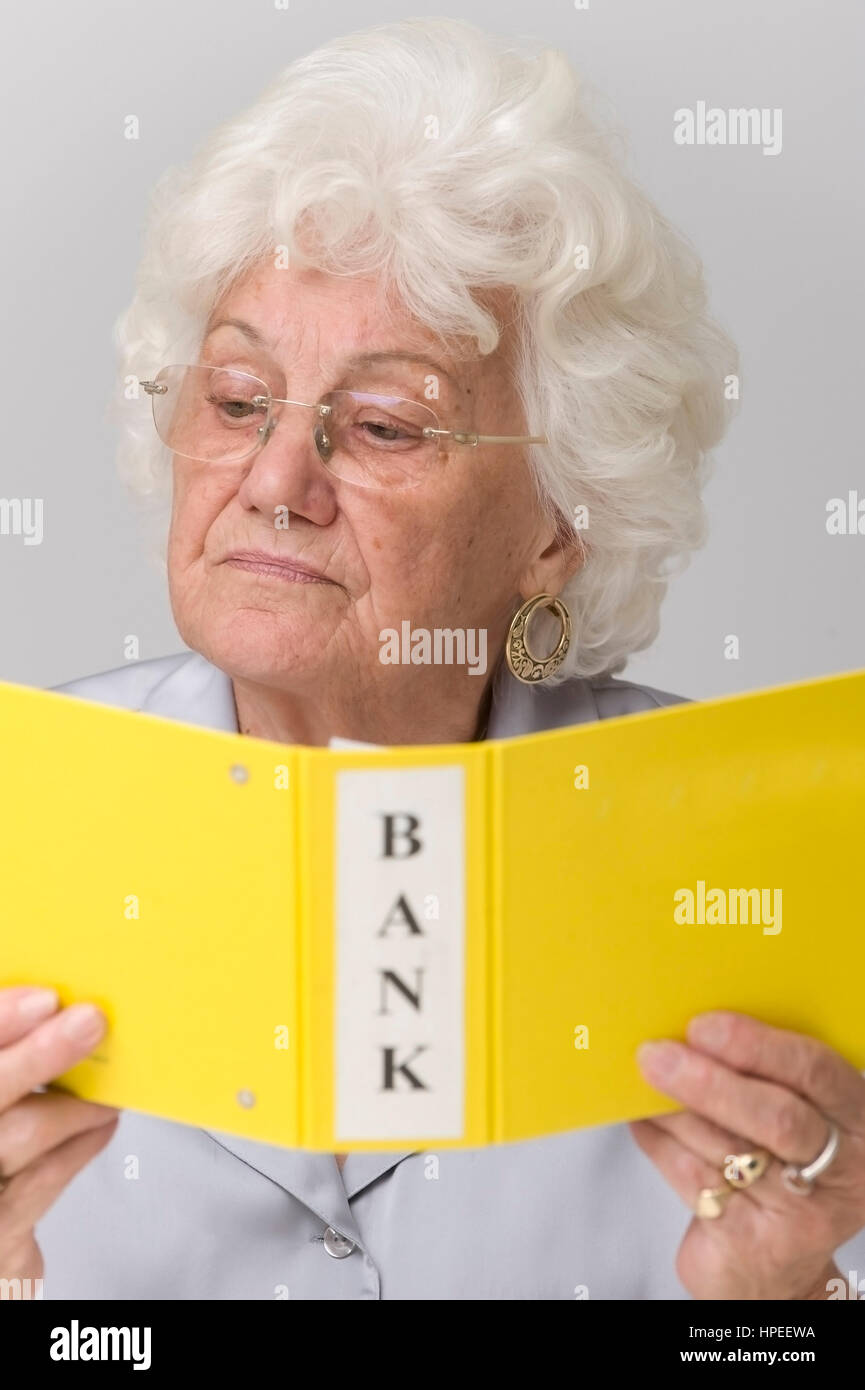 Model released , Seniorin mit Bankbelegen - older woman with bank ...