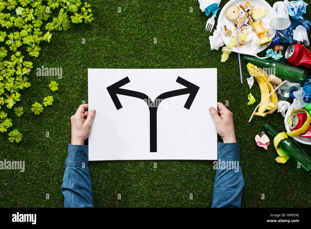 Ecology or pollution concept, man holding a sign with arrows showing ...