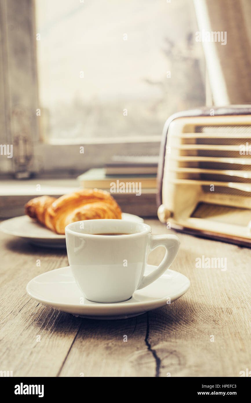 Relaxing breakfast at home next to a window with a cup of coffee on ...