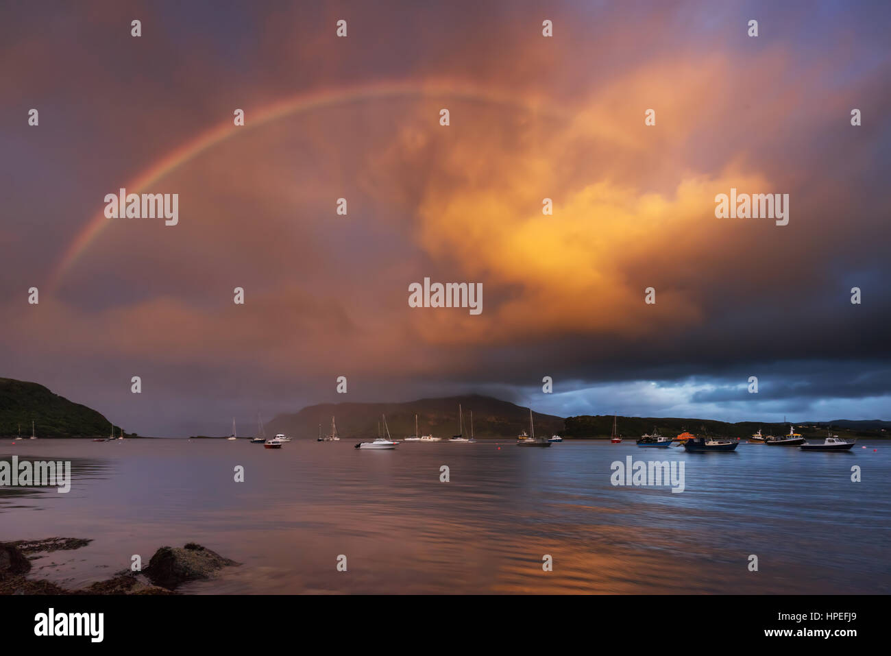 Colorful sunset and rainbow in Portree Bay, Isle of Skye, Scotland ...