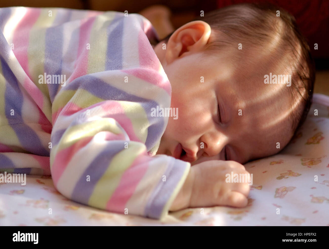 Baby Sleeping in morning light Stock Photo - Alamy