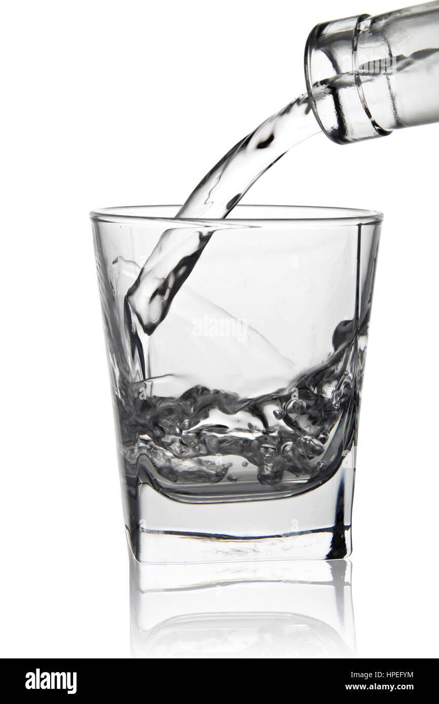 Water pouring into glass close-up view isolated on white background Stock Photo - Alamy