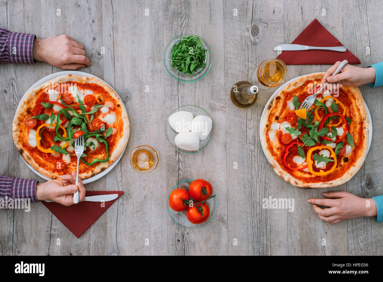 Friends eating a tasty pizza together at the restaurant, the ...