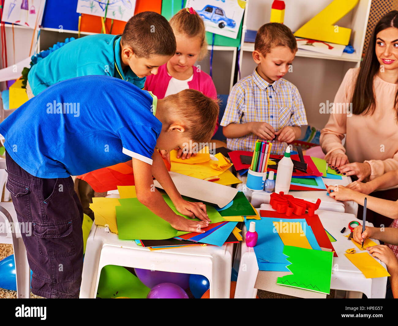 Children cutting paper in class. Kids development and social lerning ...