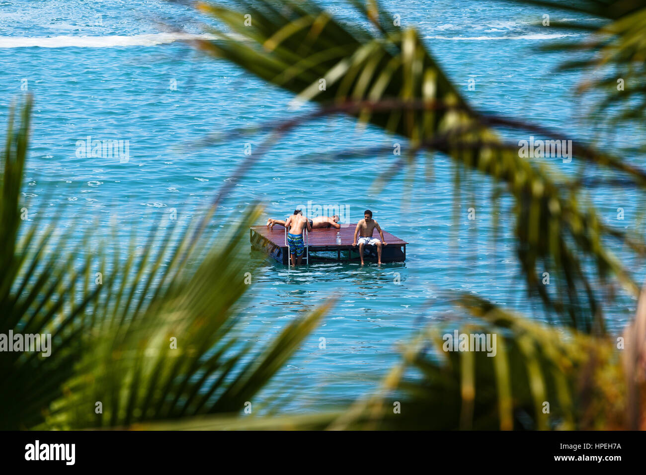 A group of friends resting on an artificial island Stock Photo - Alamy