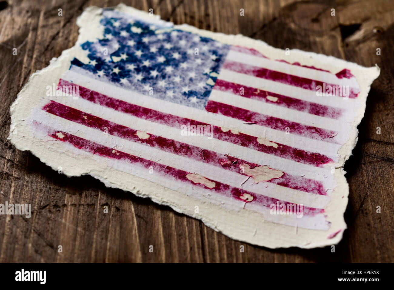 the flag of the United States in an aged piece of paper on a rustic ...