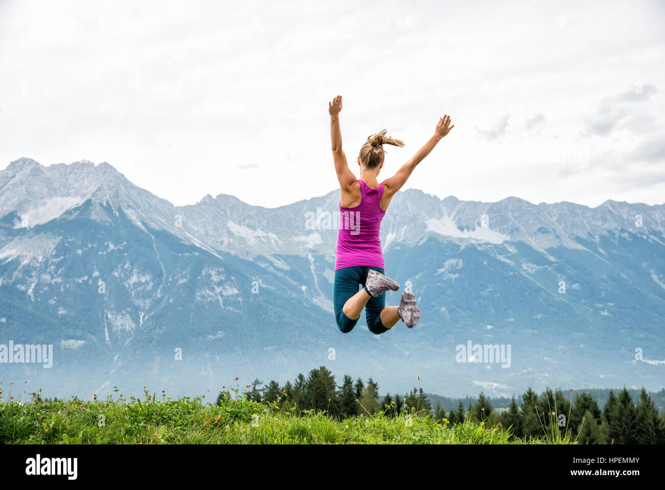 Young woman without backpack jumping in the mountains. Alps. Austria ...