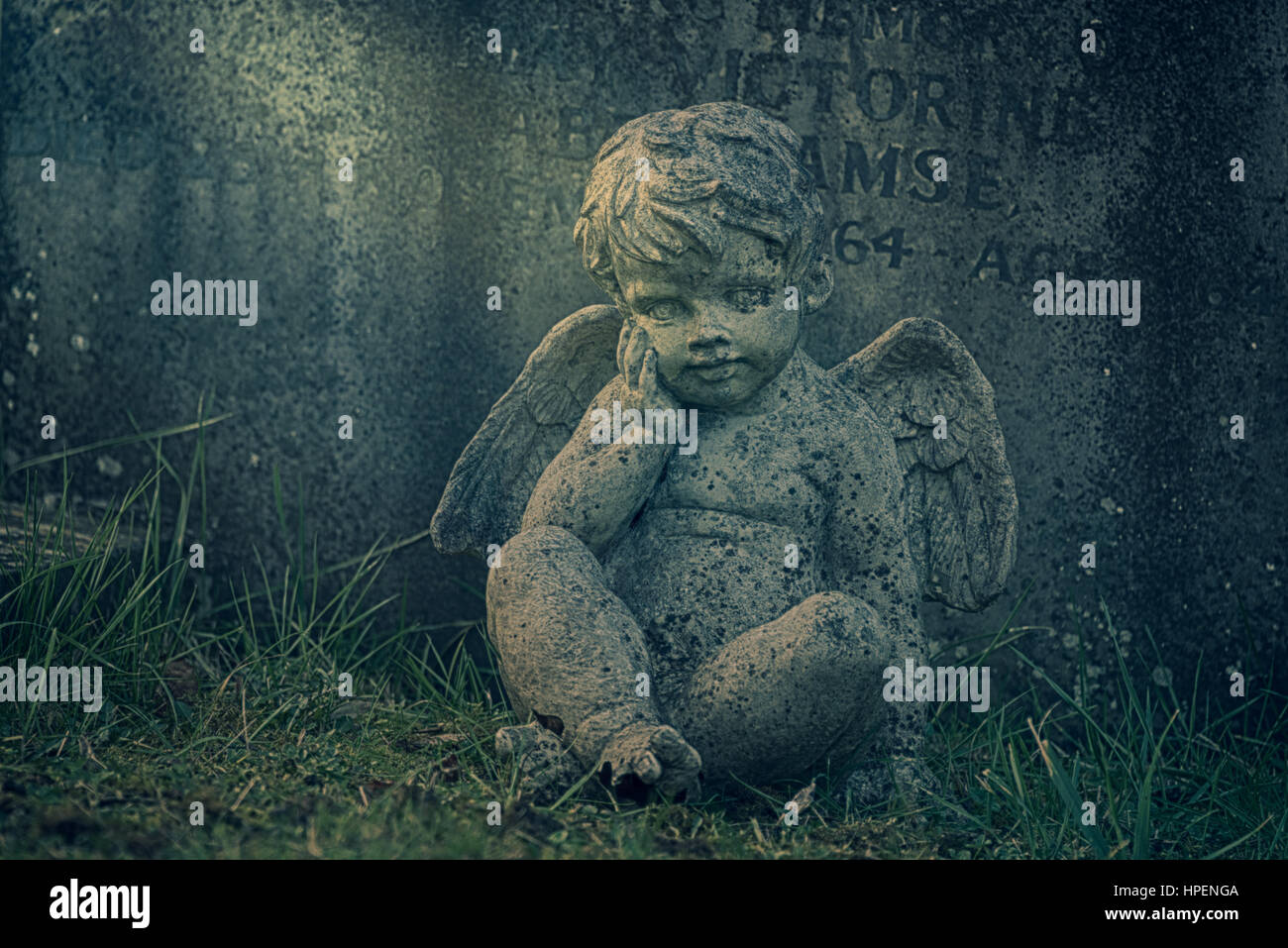 Cherub lost in thoughts thinker thinking at Highgate Cemetery Stock ...