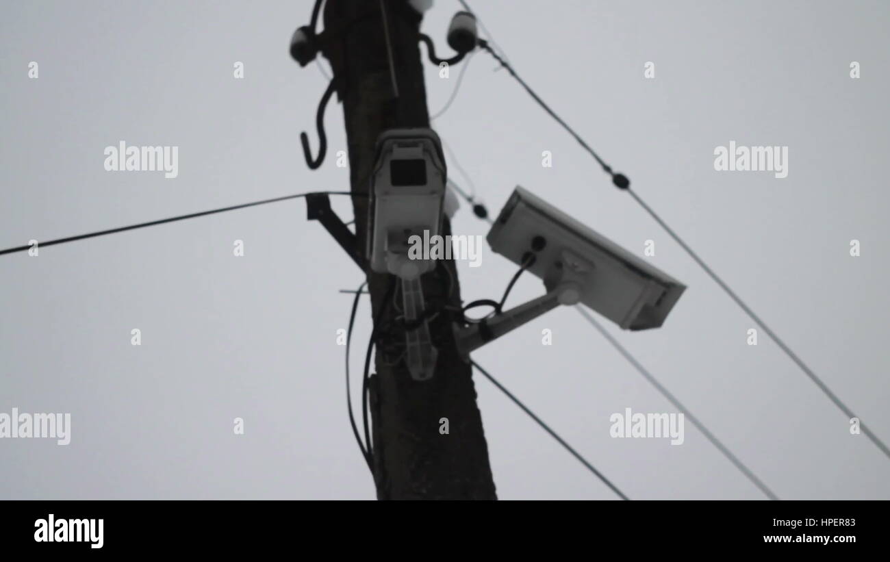 surveillance camera on a lamp post on blue sky background.CCTV Stock ...