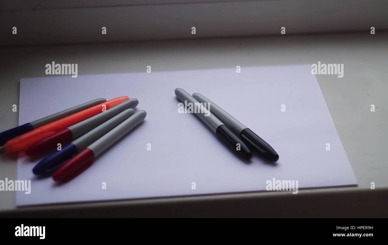colored markers on a white sheet of paper Stock Photo - Alamy