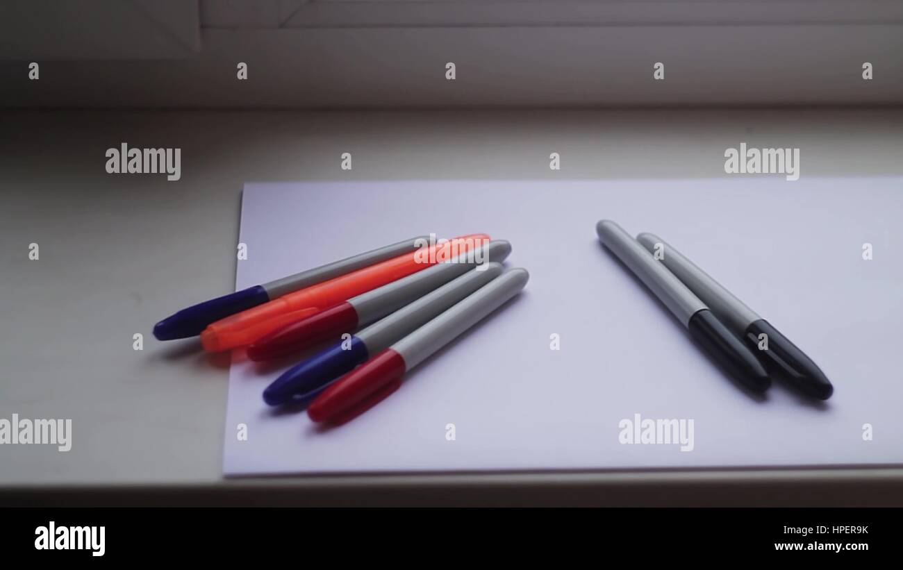 colored markers on a white sheet of paper Stock Photo - Alamy
