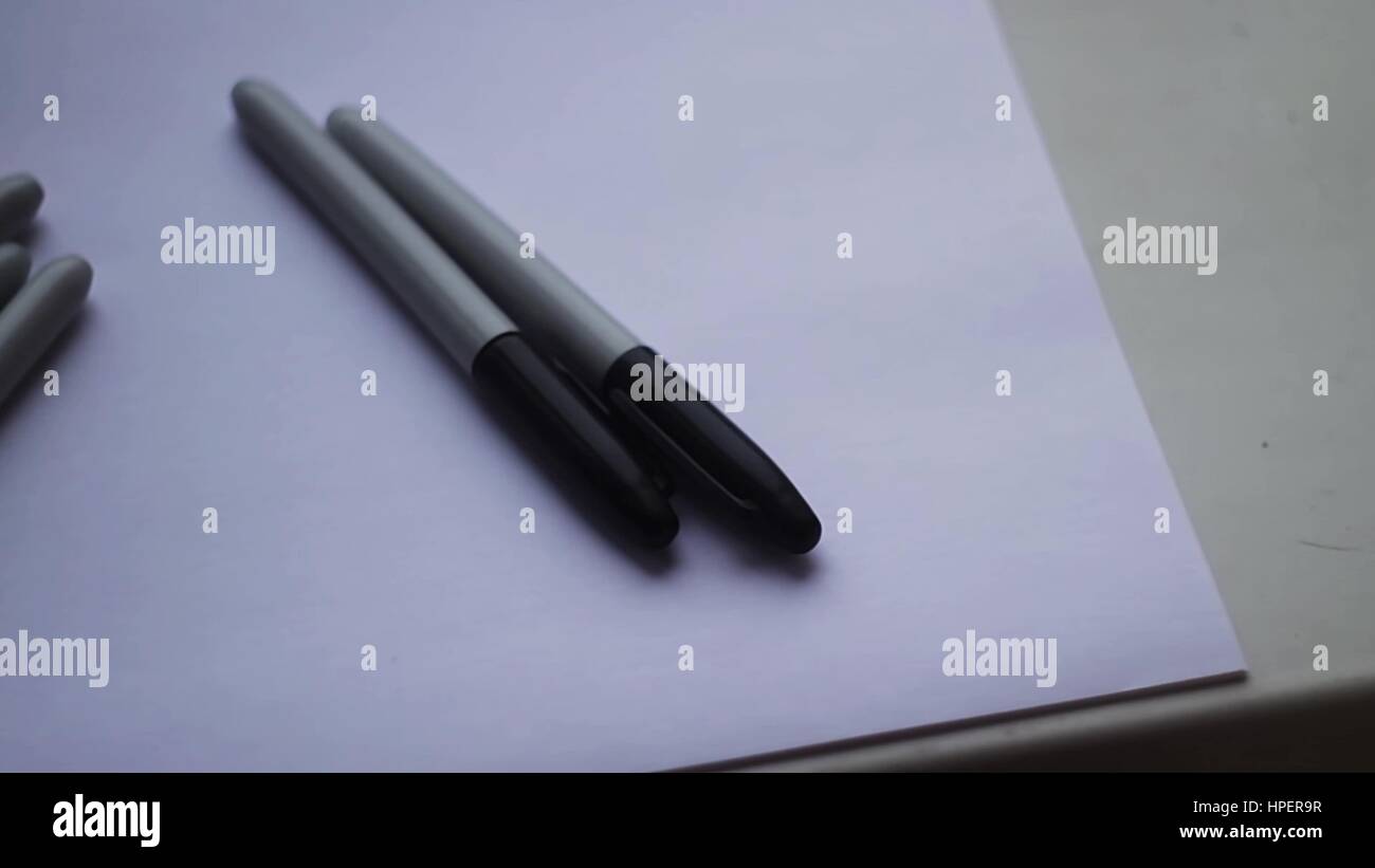 colored markers on a white sheet of paper Stock Photo - Alamy