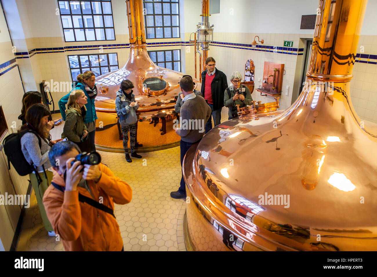 Visitors, Brewing room with mash tun copper tanks, in Augustiner Brau ...