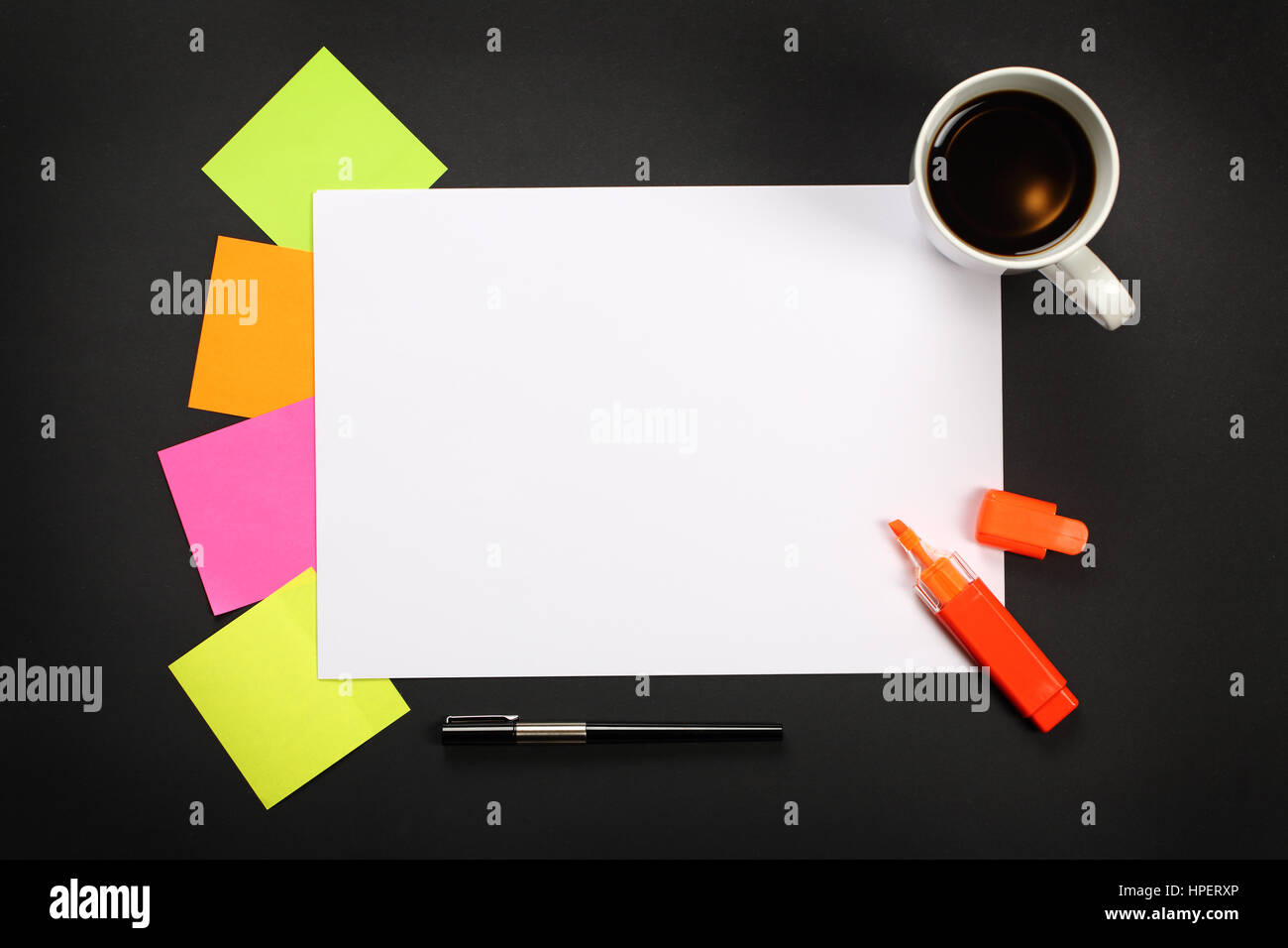 Blank sheet of paper, yellow sticky notes and pen on bright wooden ...
