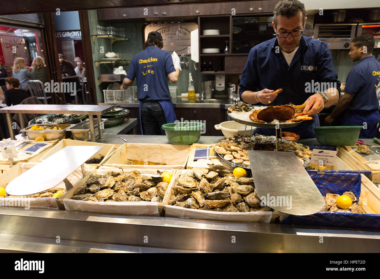 Chefs assistants preparing seafood at Les Halles de Lyon Stock Photo ...