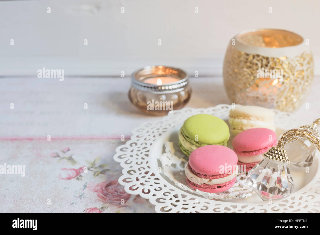 Still life with old fine things and macarons Stock Photo - Alamy