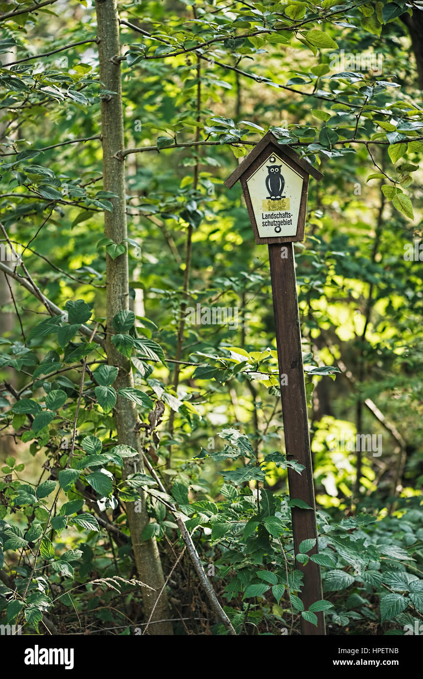 Nature protection sign in the forest in the backlight Stock Photo - Alamy