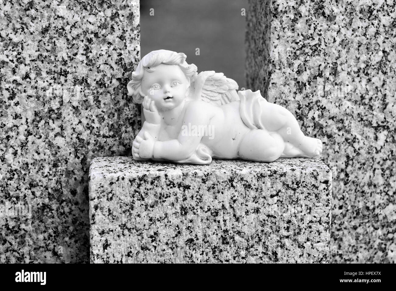 Lying angel on a granite grave stone Stock Photo - Alamy