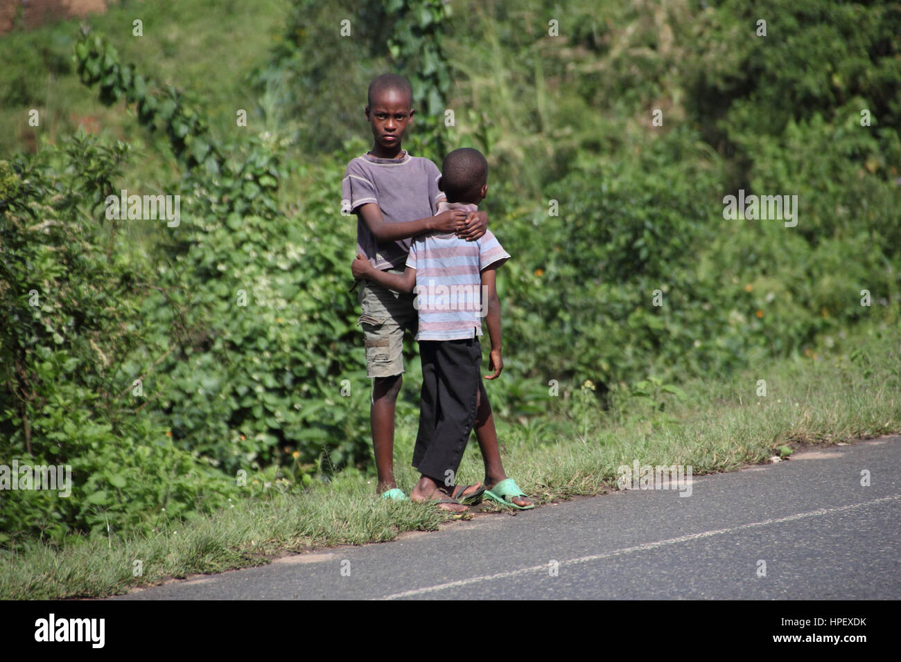 Two kids at the roadside in Uganda Stock Photo - Alamy