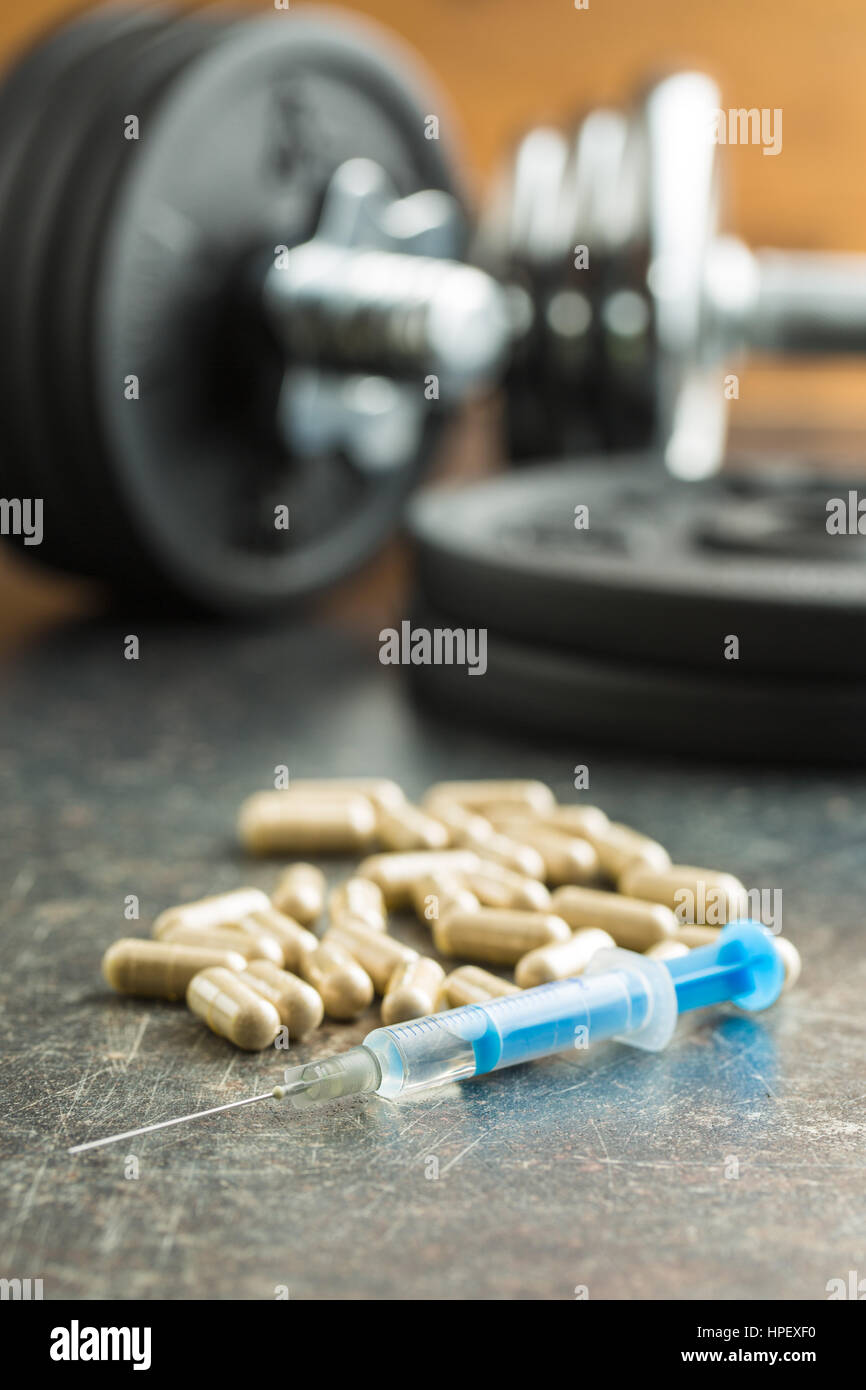 Doping in sport. Syringe and dumbbell Stock Photo - Alamy