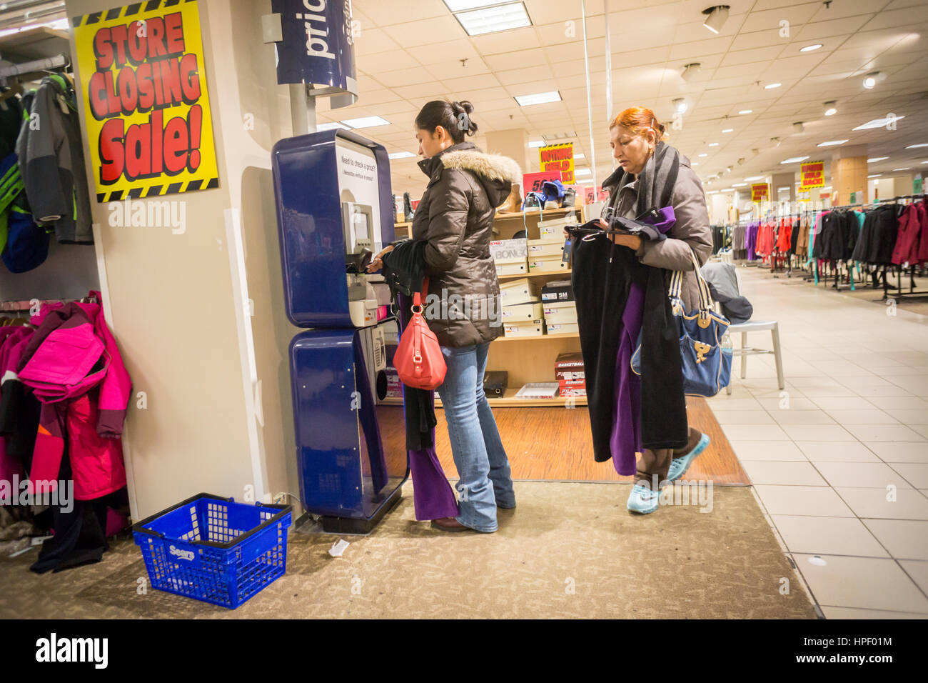 Customers use a price scanner at the soon to be closing Sears store in ...