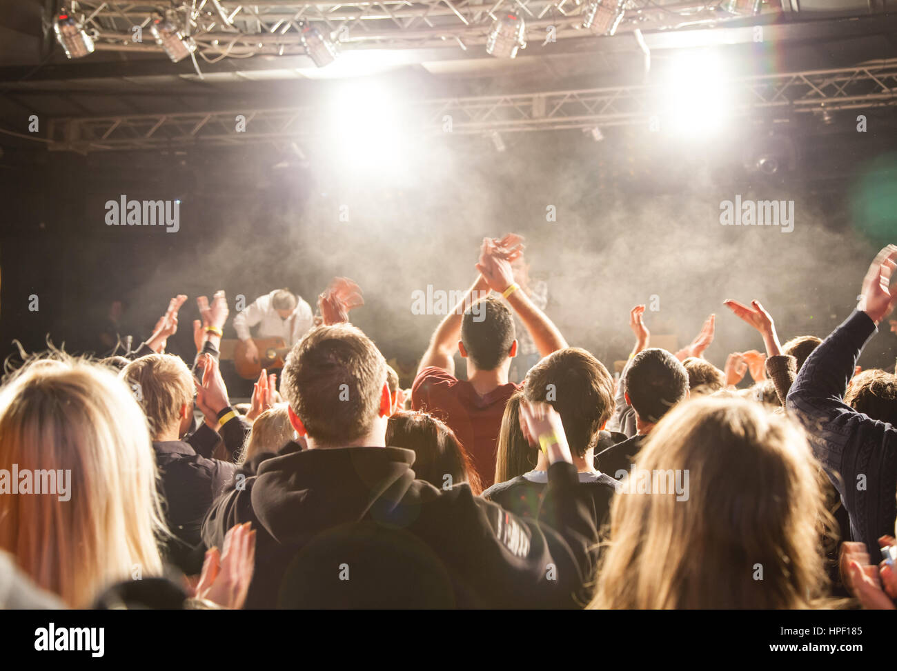 The audience applauded by the stage artist. They shines the spotlight ...