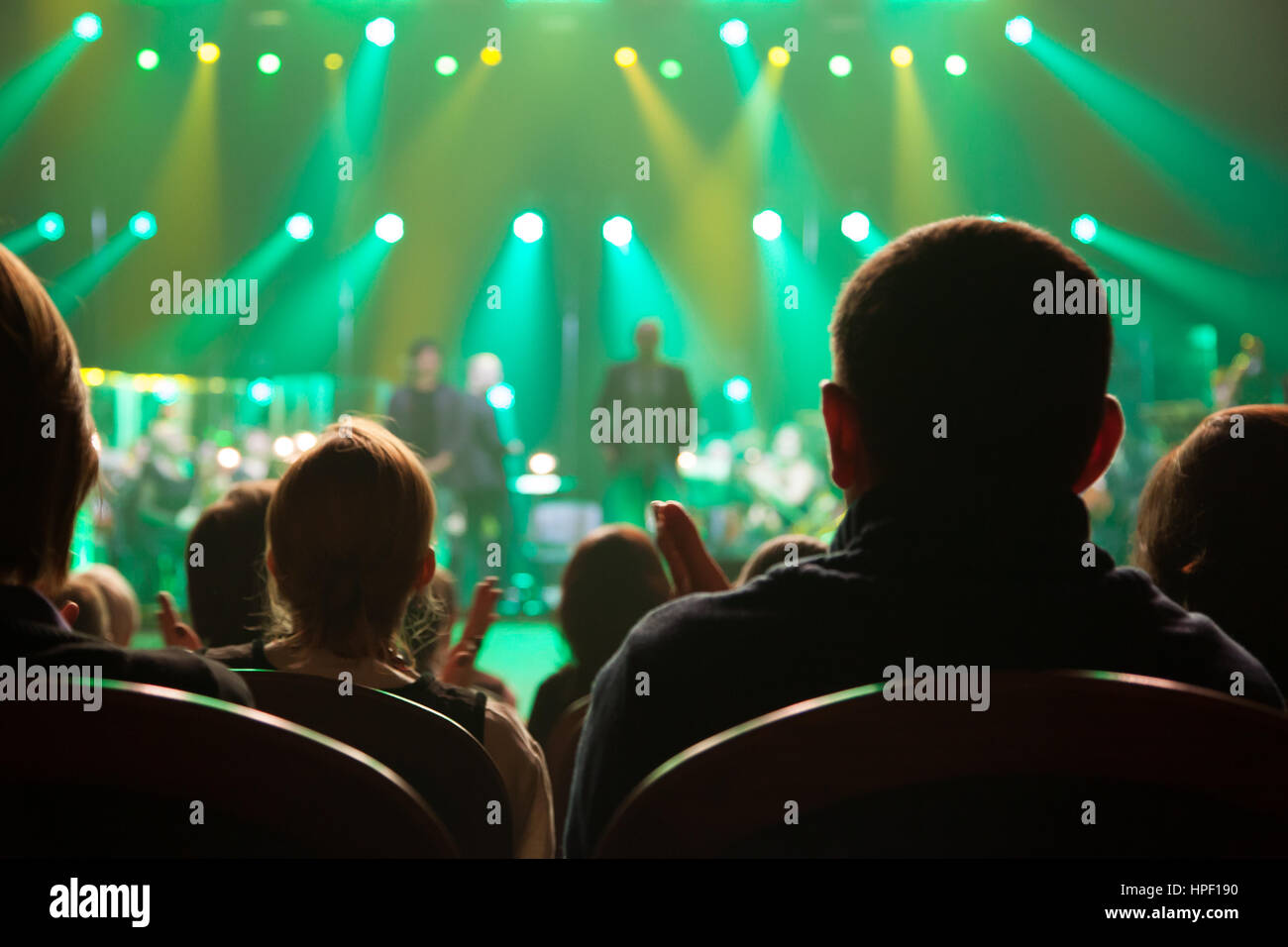 The audience applauded the artists on stage Stock Photo - Alamy
