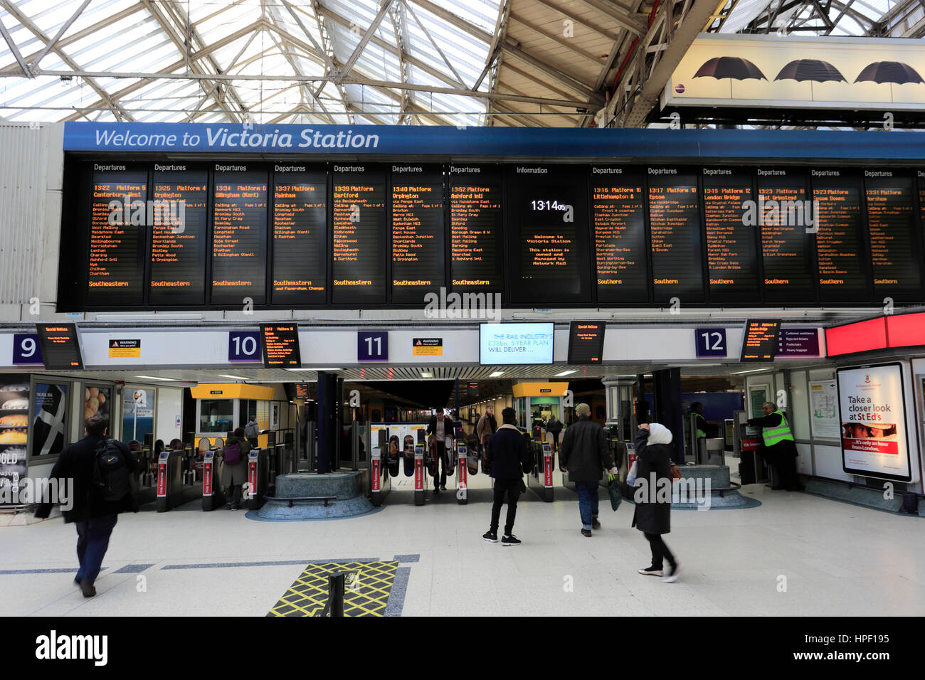 People on the concourse and departure boards; Inside Victoria railway ...