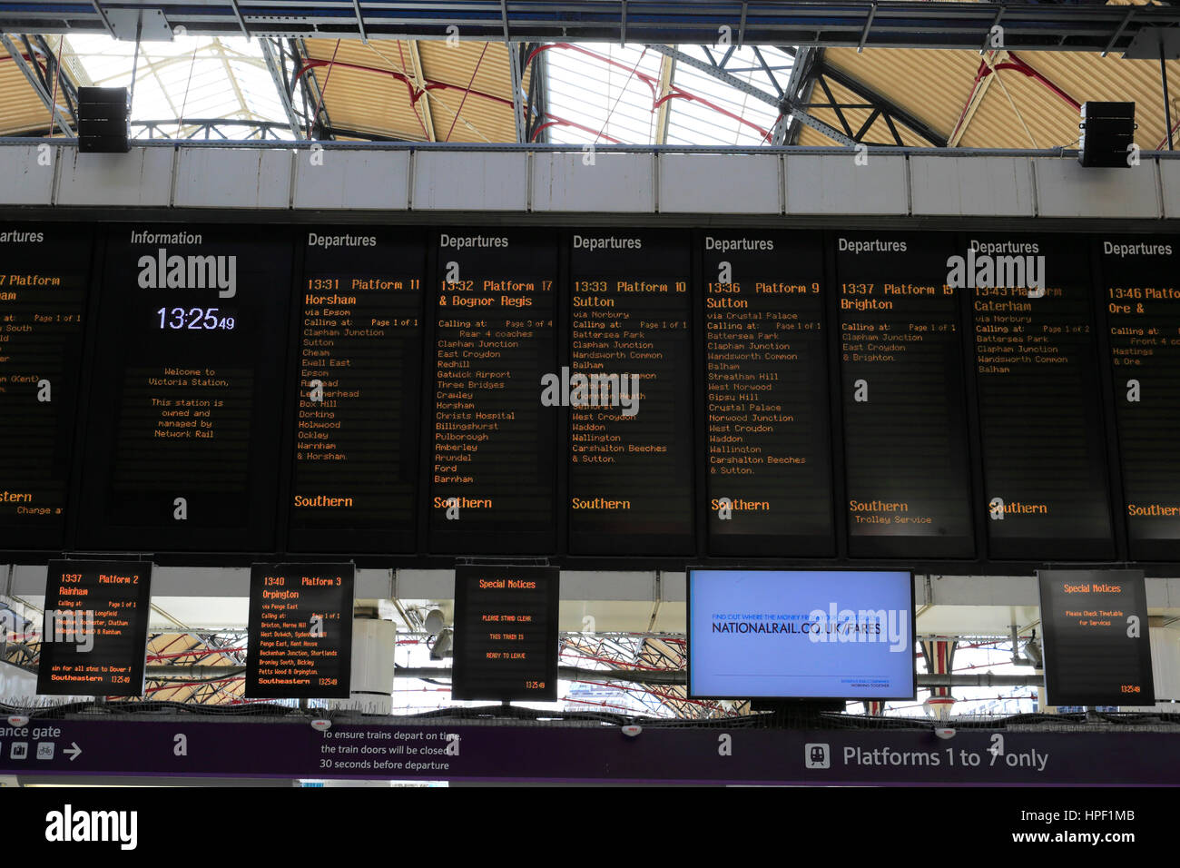 People on the concourse and departure boards; Inside Victoria railway ...