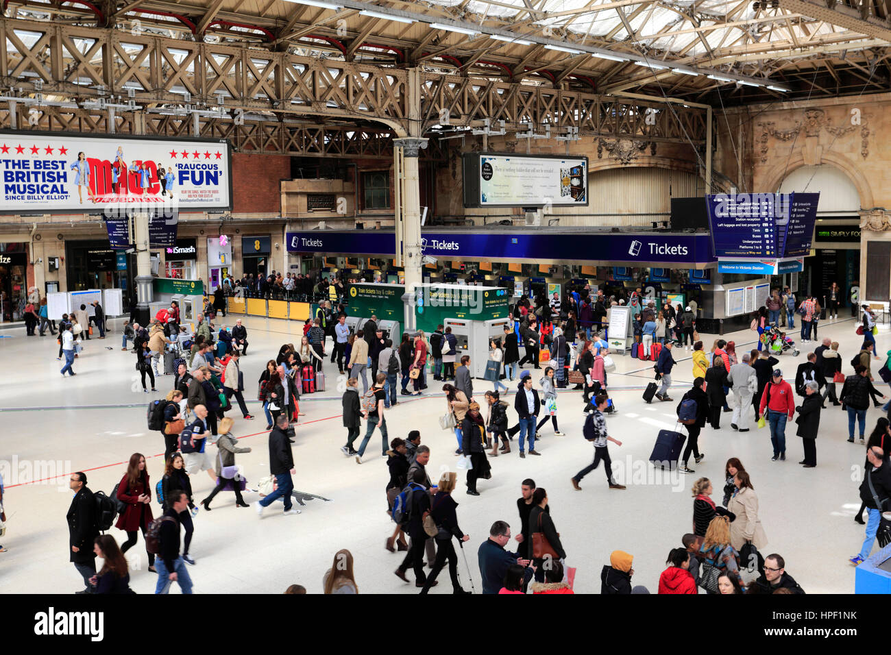 People on the concourse and departure boards; Inside Victoria railway ...