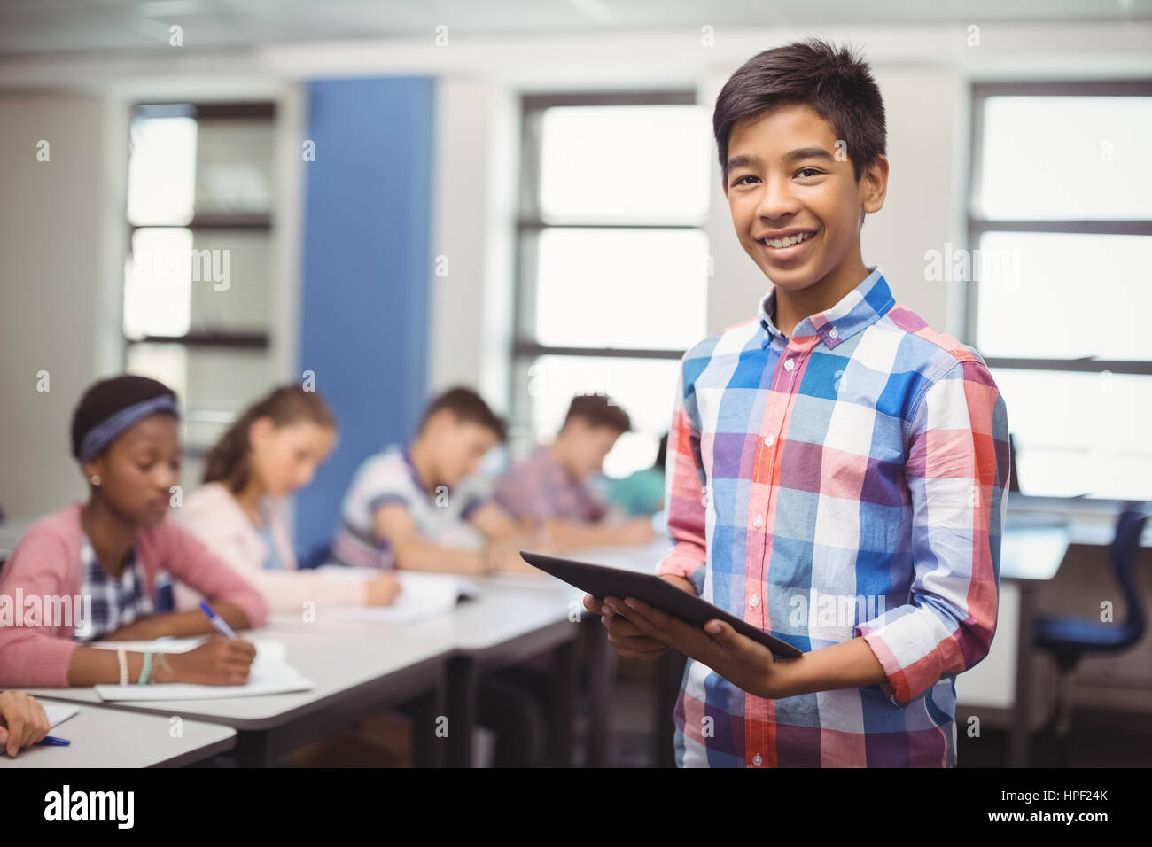 Portrait of schoolboy giving presentation in classroom at school Stock ...