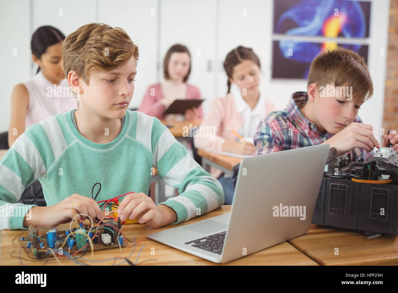 Schoolboys working on electronical project in classroom at school Stock ...