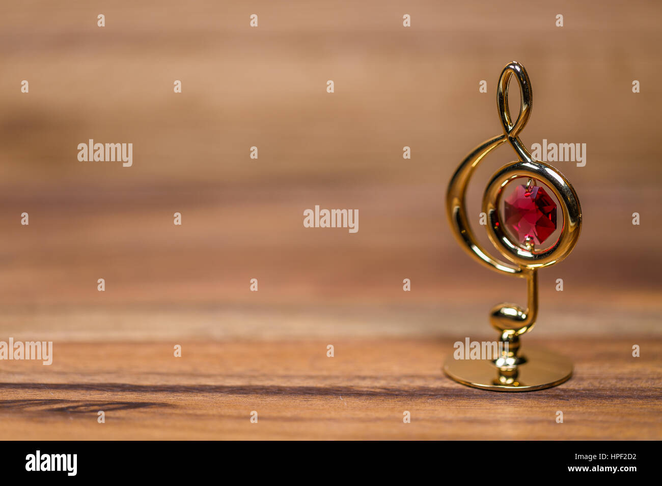 Golden Treble Clef Figurine With Red Crystal Stock Photo - Alamy