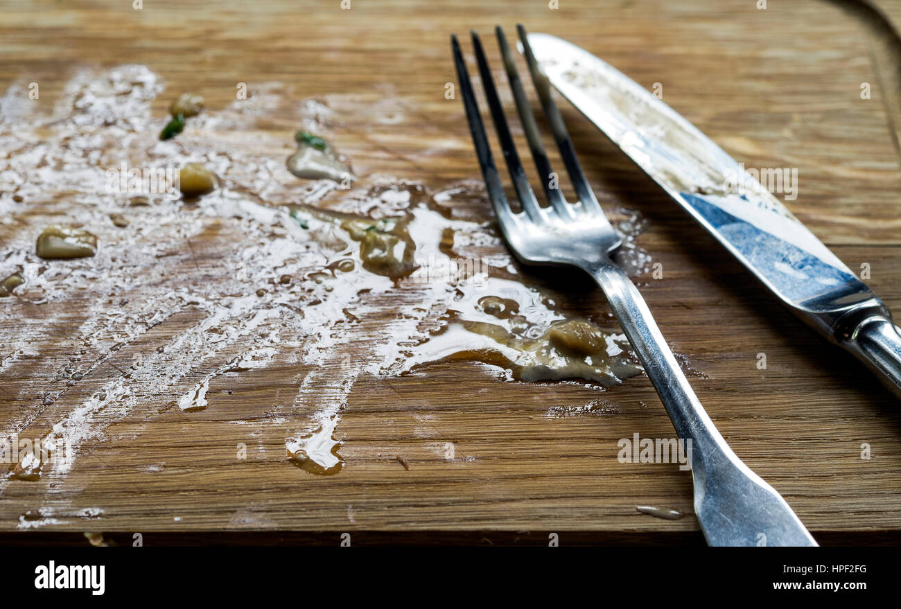 Board dirty after eating with fork and knife. Selective focus Stock ...