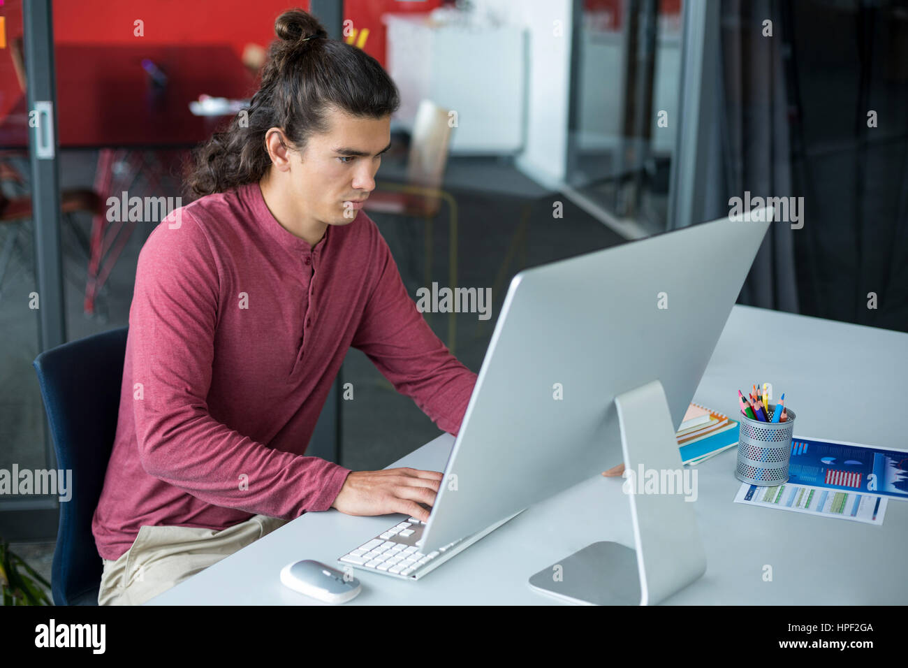 Male executive working on personal computer in office Stock Photo - Alamy