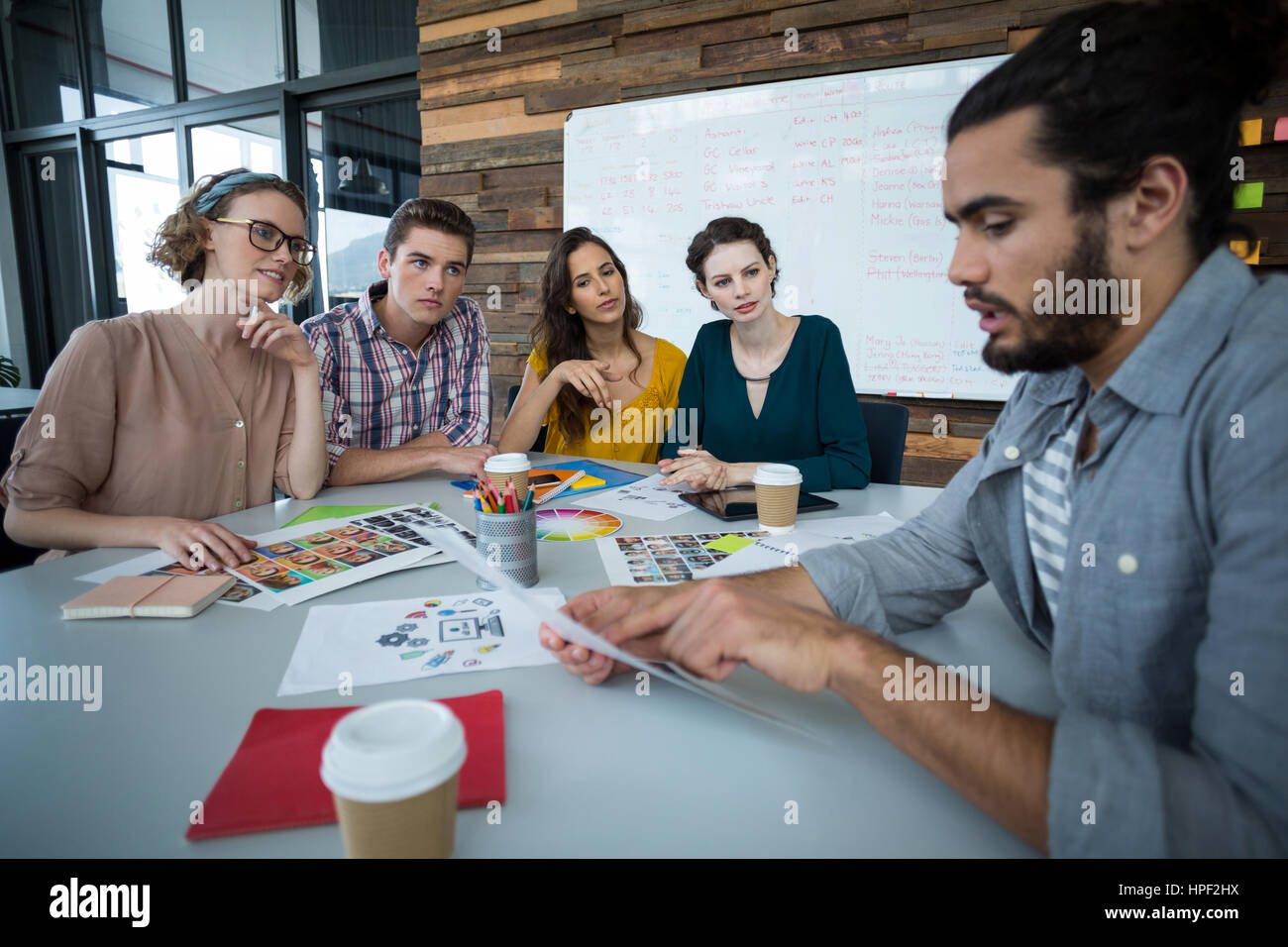 Graphic designers working together in office Stock Photo - Alamy
