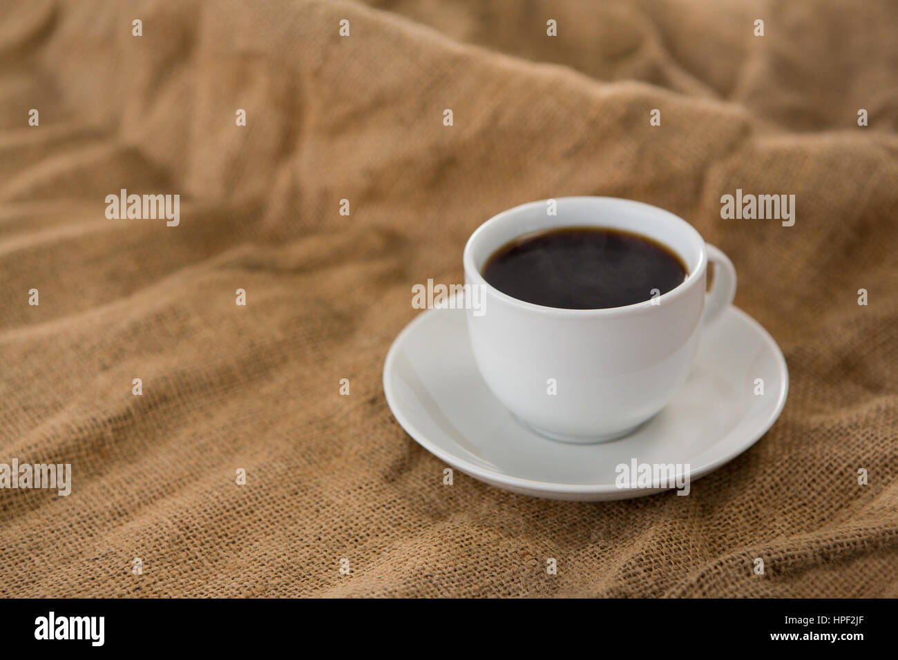 Black coffee served on sack textile Stock Photo - Alamy