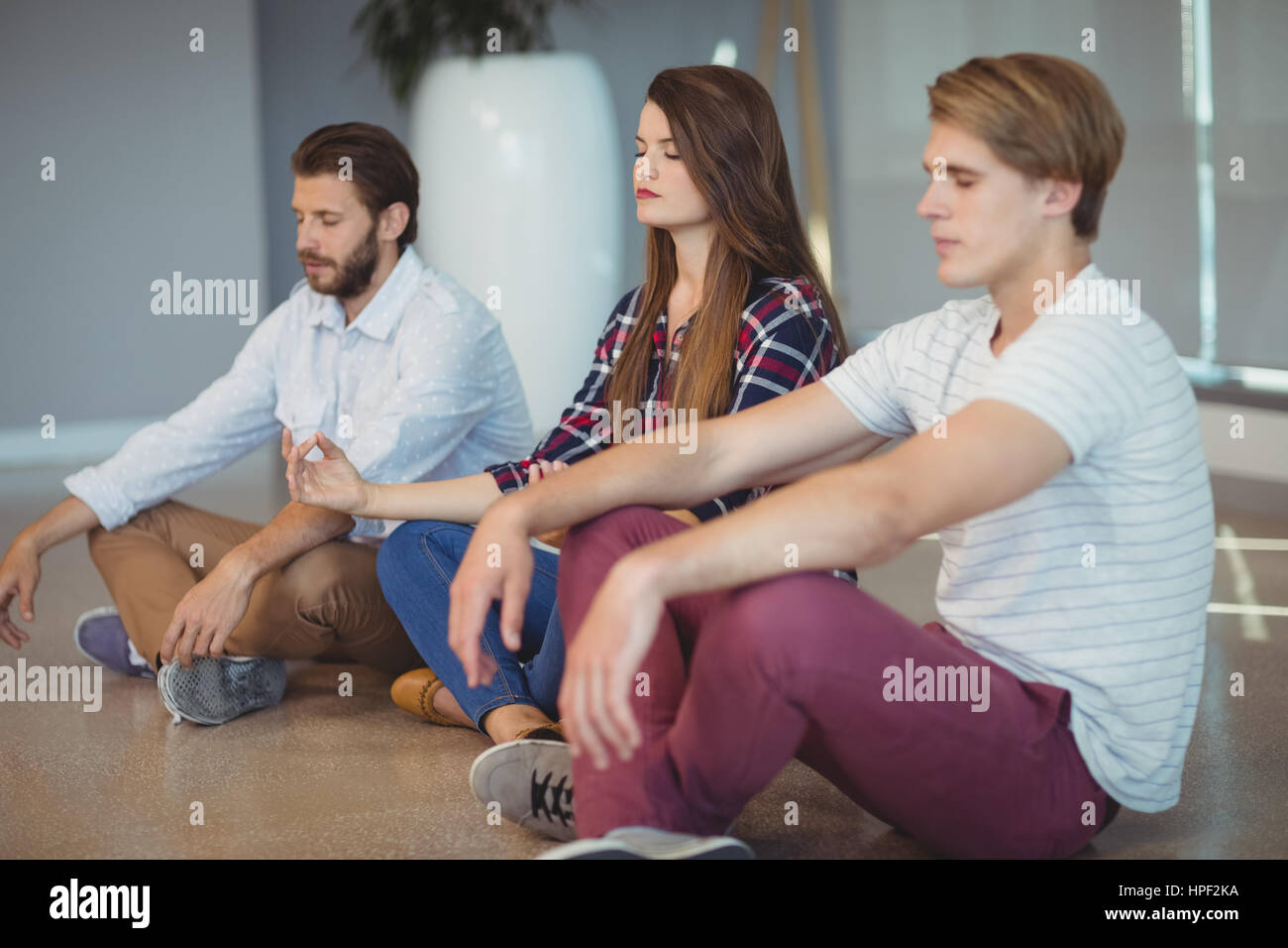 Business executives practicing yoga in office Stock Photo - Alamy