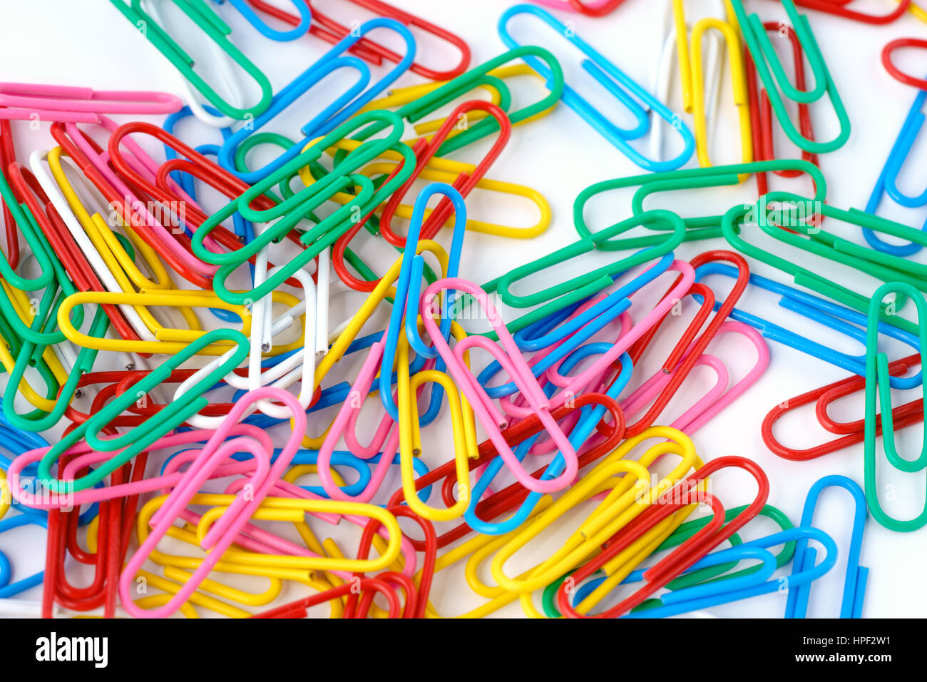 Colorful paperclips on white background Stock Photo - Alamy