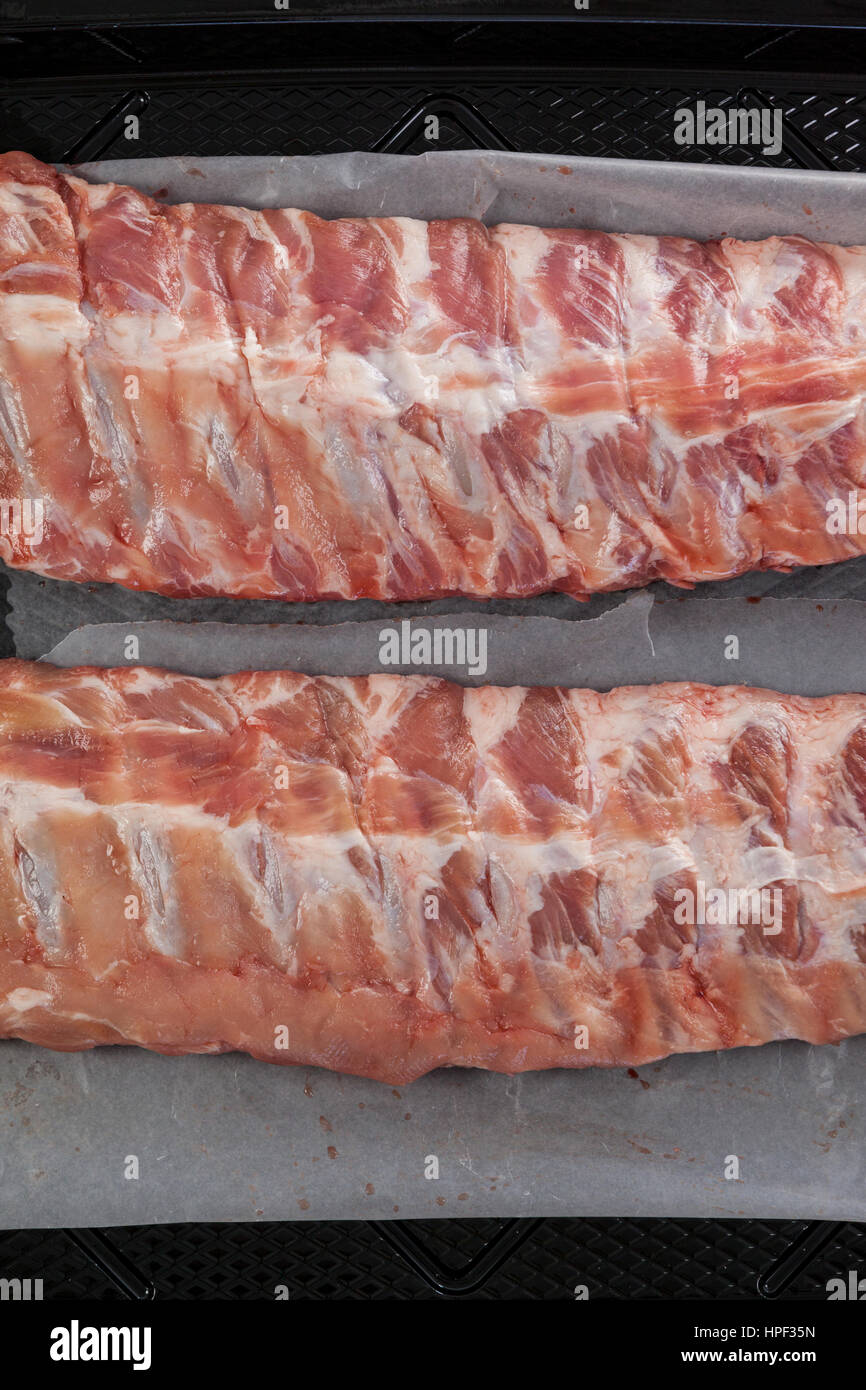 Beef ribs in black box against wooden background Stock Photo - Alamy