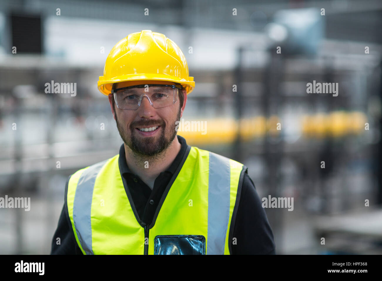 Smiling factory worker standing hi-res stock photography and images - Alamy
