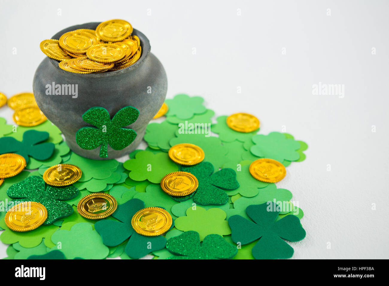 St. Patricks Day shamrock and pot filled with chocolate gold coins on ...