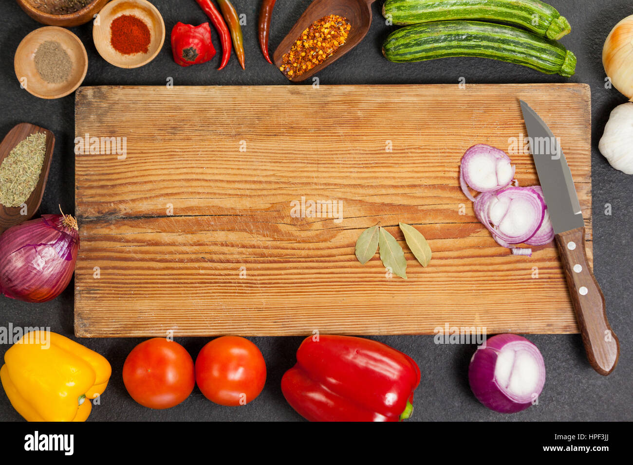 Wooden tray with ingredients against black background Stock Photo - Alamy