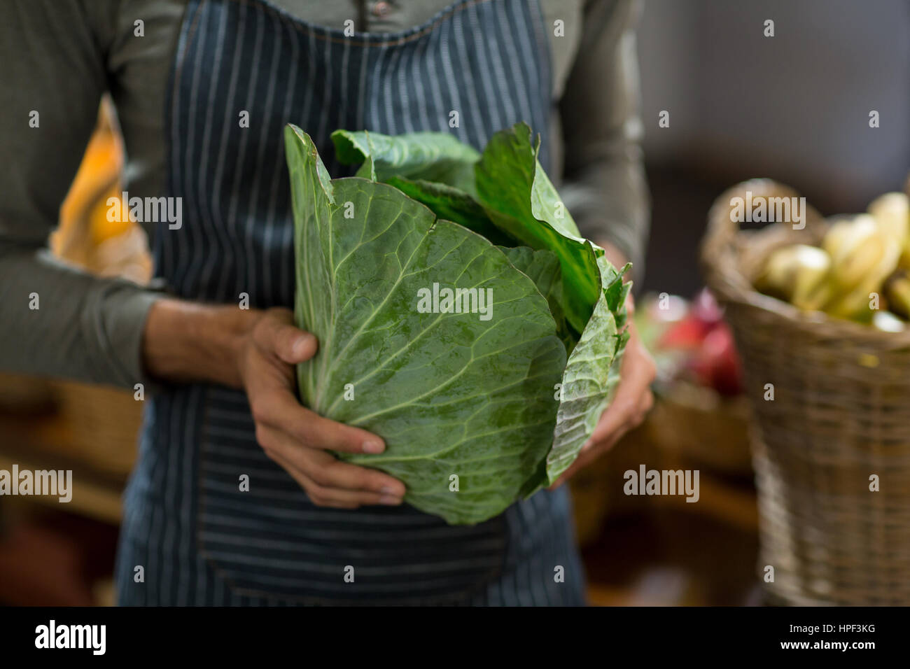 Man holding cabbage hi-res stock photography and images - Alamy