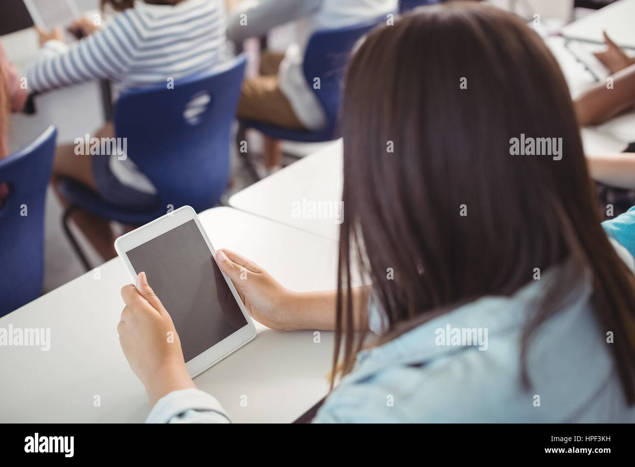 Student using digital tablet in classroom at school Stock Photo - Alamy