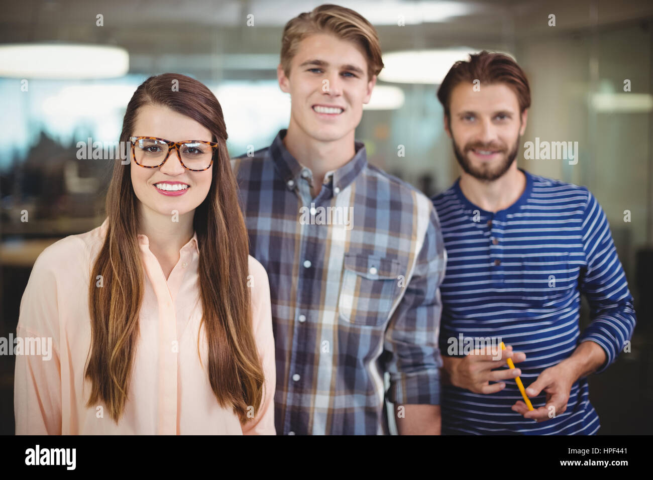 Portrait of happy executives standing in office Stock Photo - Alamy