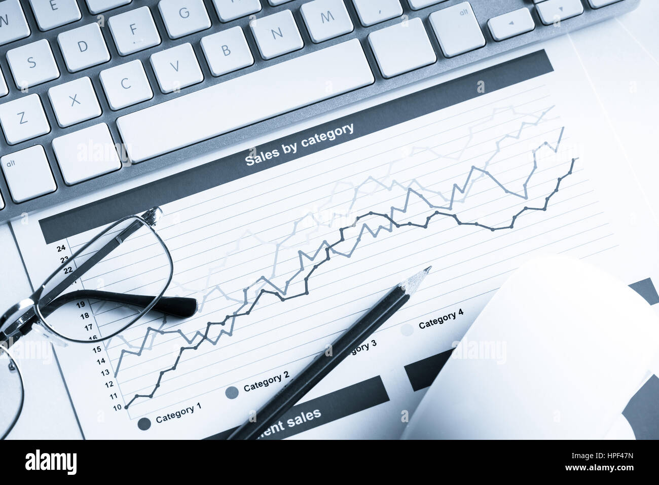 Business workplace with keyboard mouse and papers with graphs and ...
