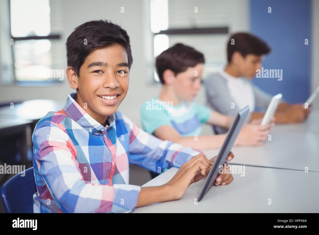 Students using digital tablet in classroom at school Stock Photo - Alamy