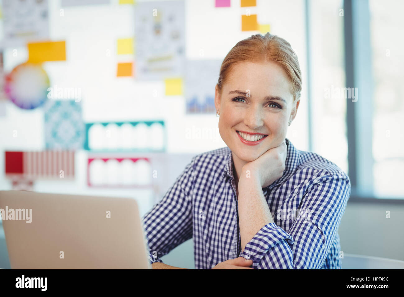 Portrait of smiling female executive sitting in office Stock Photo - Alamy
