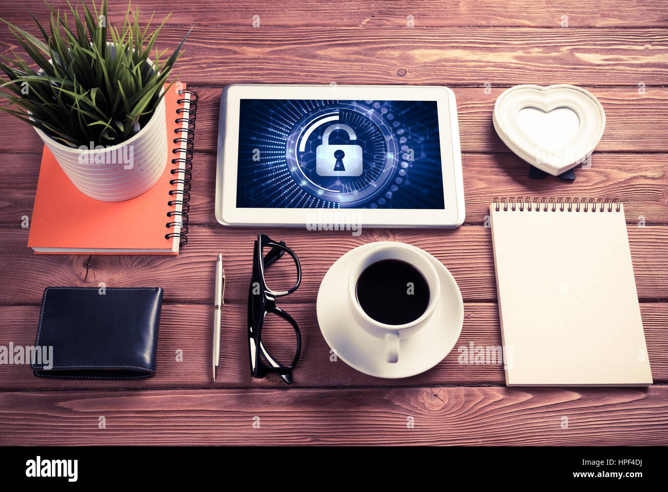Business workplace with office stuff and tablet with padlock icons on ...